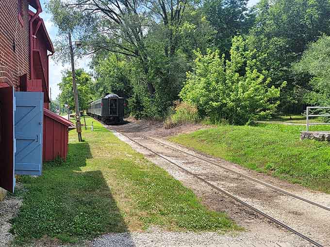 Quiet tracks stretching into green distance, waiting patiently for the next adventure to roll through town.