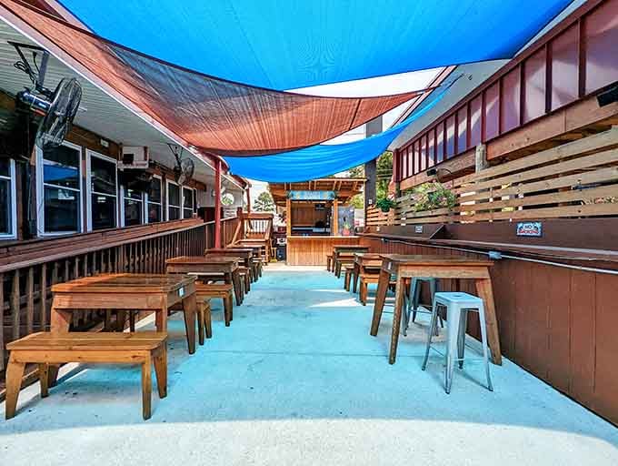 Outdoor seating under colorful shade sails: because sometimes the best seafood tastes even better under open sky.