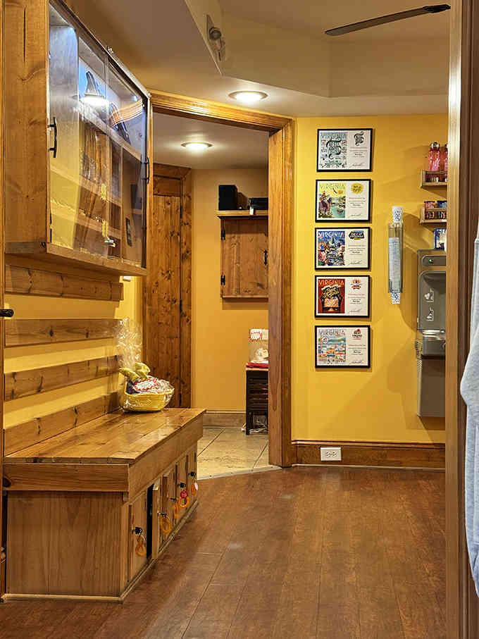 The hallway's warm golden walls and framed certificates create an inviting path toward your personal relaxation destination ahead.