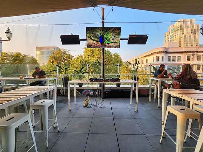 White metal furniture keeps things casual and breezy while downtown buildings frame your afternoon perfectly.