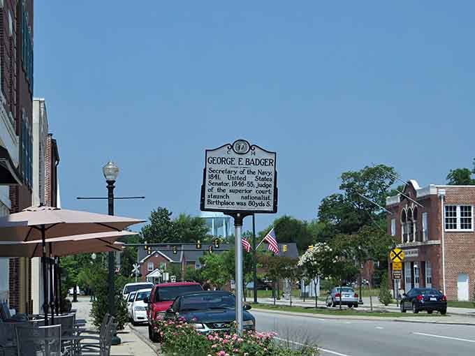 Historic markers tell stories on streets where outdoor dining and flower boxes create perfect small-town charm.