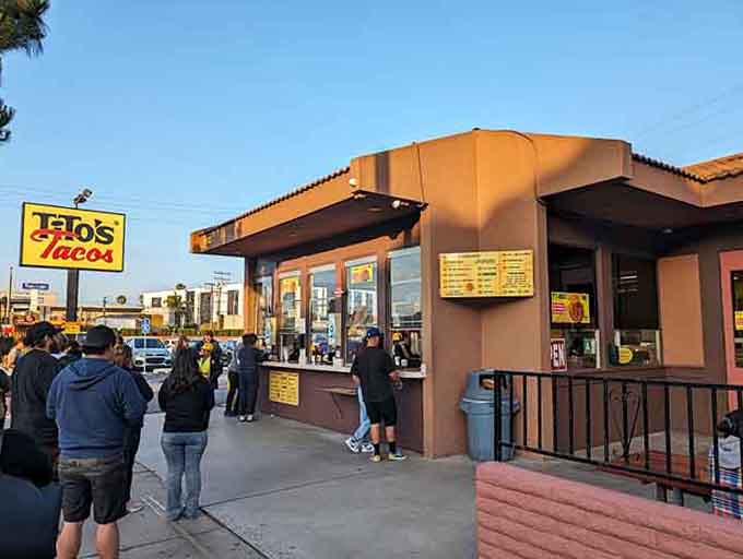 That bright yellow sign draws crowds like moths to a flame, and the tacos inside justify every minute waiting.