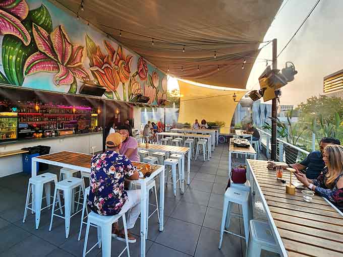 Vibrant tropical murals bring island energy to this lively spot where locals gather for sunset celebrations.