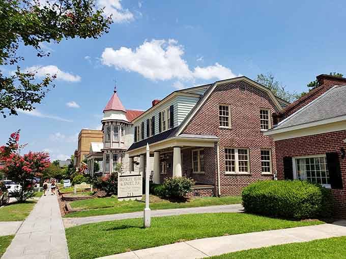 Classic brick architecture meets manicured lawns where that distinctive tower adds character to every neighborhood stroll.