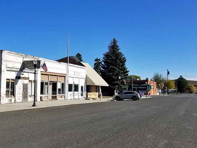 Empty streets and classic storefronts create that peaceful small-town tableau where rush hour means three cars at the stoplight.