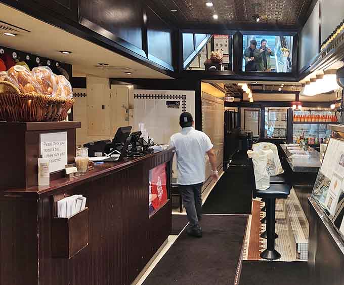 Behind that counter, deli wizards work their magic, transforming cured meats into towering works of art.