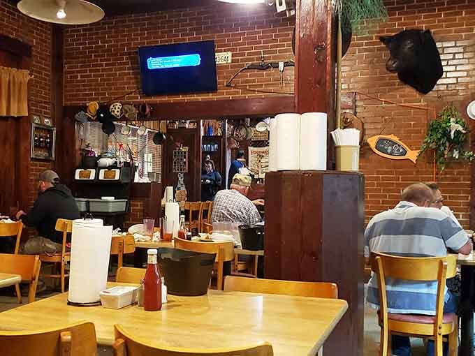 Exposed brick walls, mounted fish, and wooden accents create a cozy dining room where locals gather for their weekly feast.
