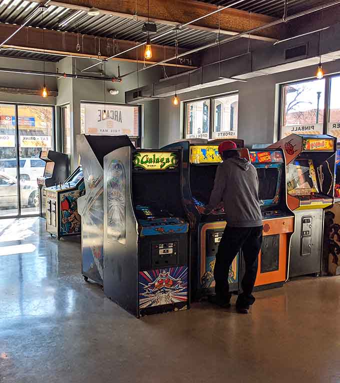 Someone's deep into Galaga mode, proving these machines still command respect and undivided attention after all these years.