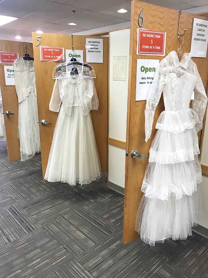 Vintage wedding dresses await their second chance at matrimonial glory in numbered fitting rooms.