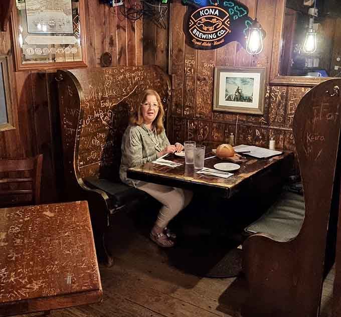 Cozy booths with carved messages on the walls tell stories of countless meals and good times shared.