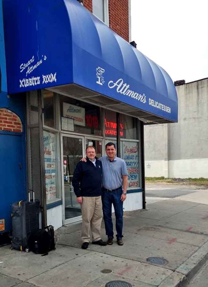 Happy customers pose outside, probably still digesting sandwiches they ordered three hours ago, totally worth it.
