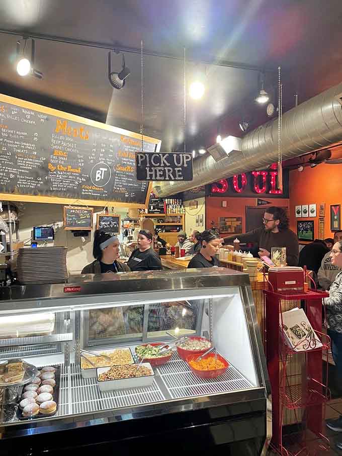 The bustling order counter with its chalkboard menu and busy staff captures the energy of a place people genuinely love.