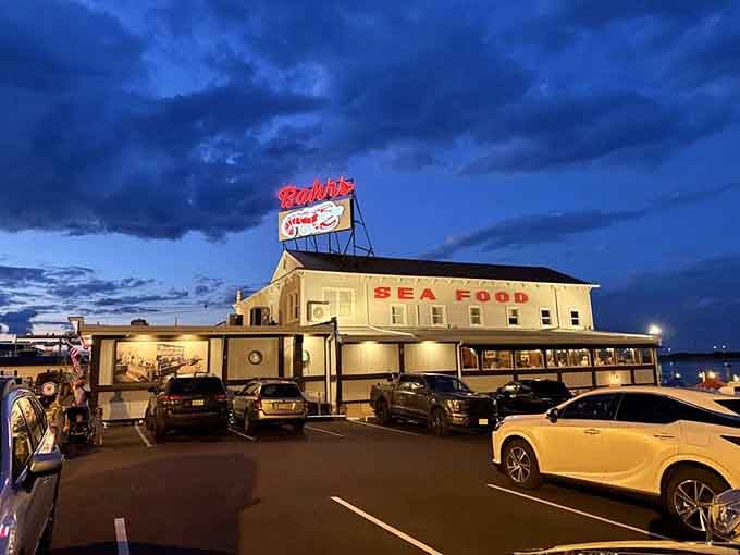 Even the parking lot view promises good things ahead, with that vintage sign standing tall like a beacon of fried seafood hope.