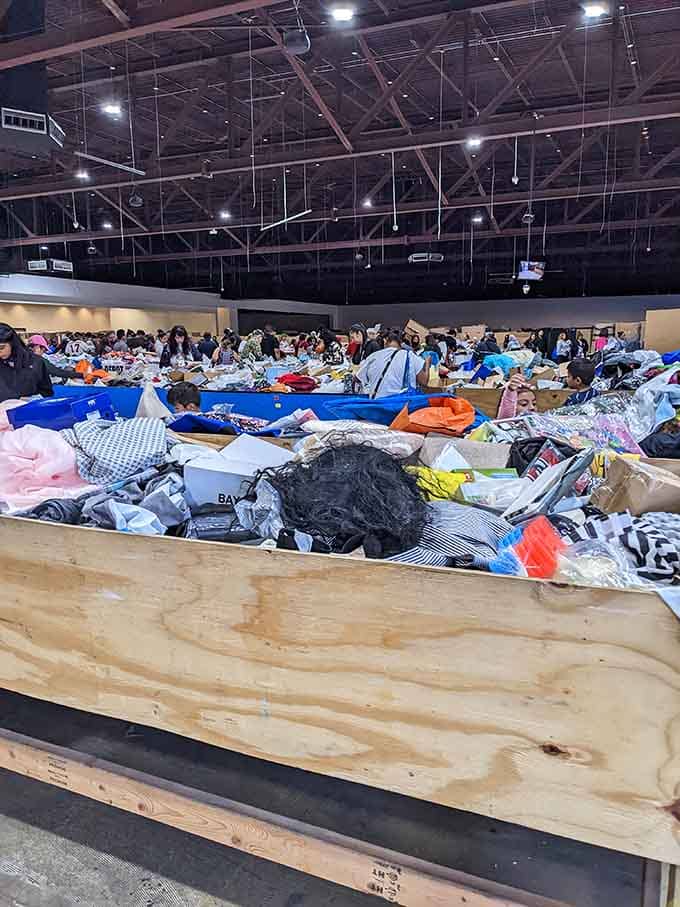 Massive tables covered in clothing create a sea of possibilities for shoppers willing to dive in and explore.