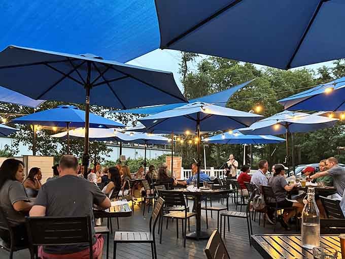 Blue umbrellas create an outdoor oasis where brunch extends into the fresh air and good vibes multiply.