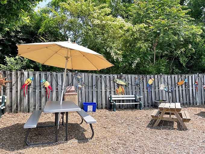 Shaded tables and colorful parrots on the fence create a backyard oasis where burgers taste even better alfresco.