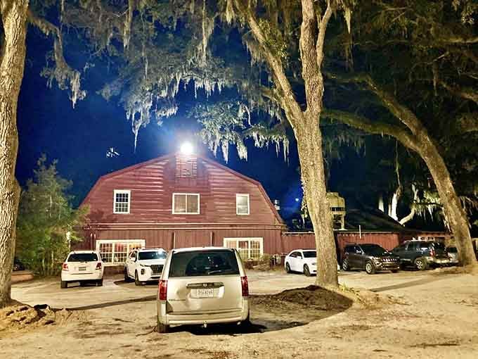 Even the parking lot looks inviting at night when those ancient live oaks frame the barn in Southern Gothic perfection.