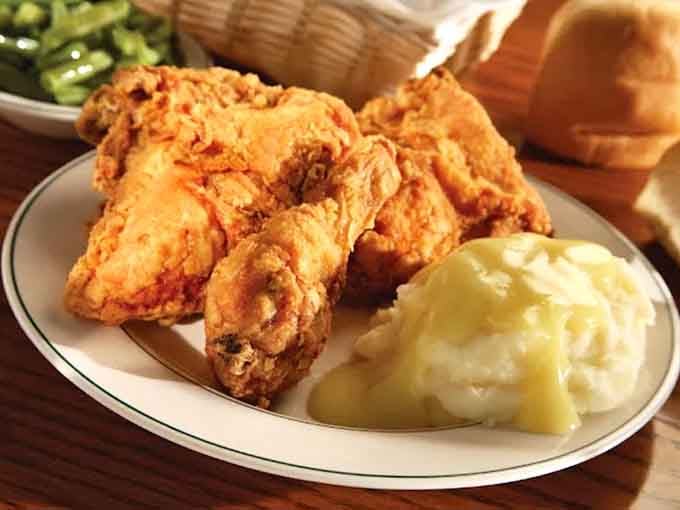 Golden fried chicken that's crispier than your uncle's jokes and infinitely more satisfying to experience firsthand.