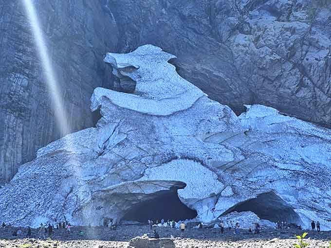 Visitors gather safely outside, smart enough to admire the spectacle without becoming part of it.