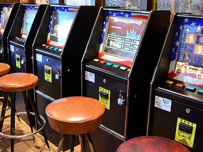 A few gaming machines add modern entertainment options without overwhelming the vintage bowling alley atmosphere.