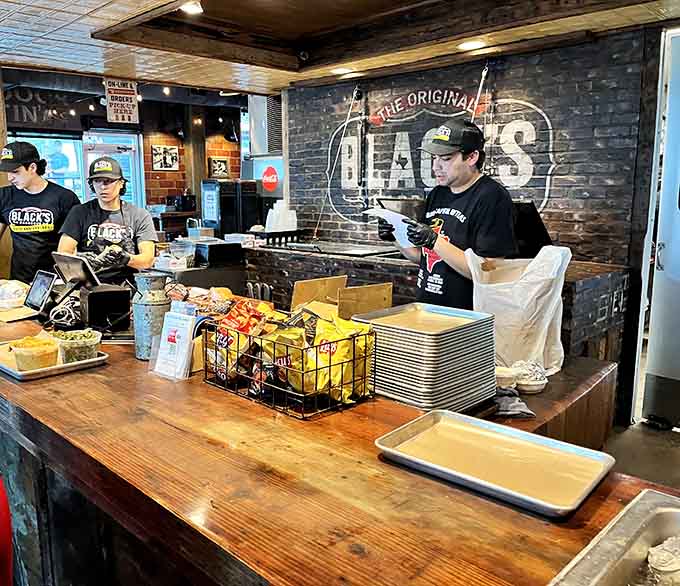 The crew behind the counter works with practiced efficiency, slicing and serving barbecue perfection all day long.