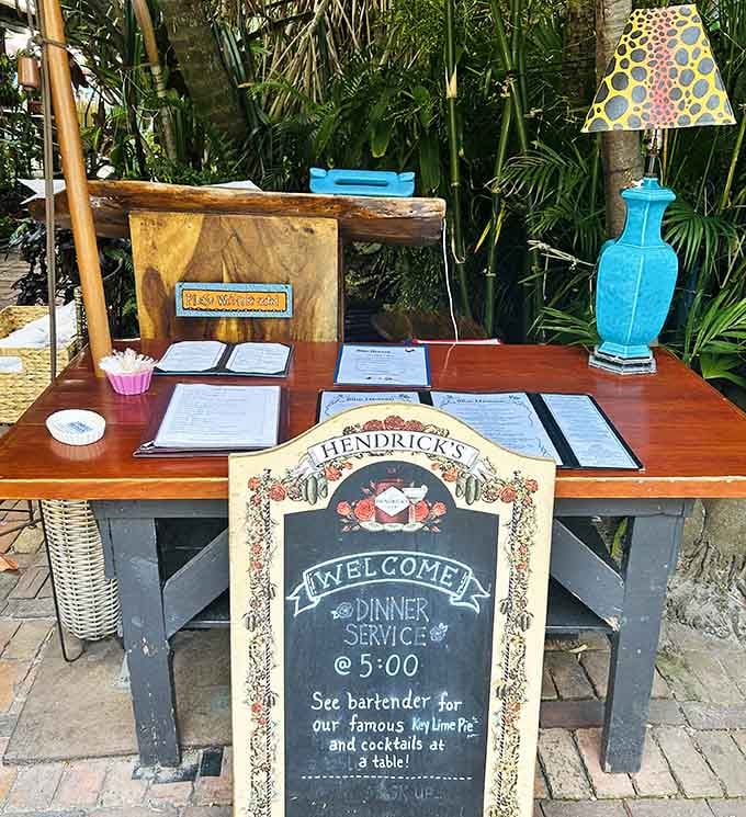 The hostess stand sits under palm fronds like a tropical checkpoint between your hungry present and delicious future.