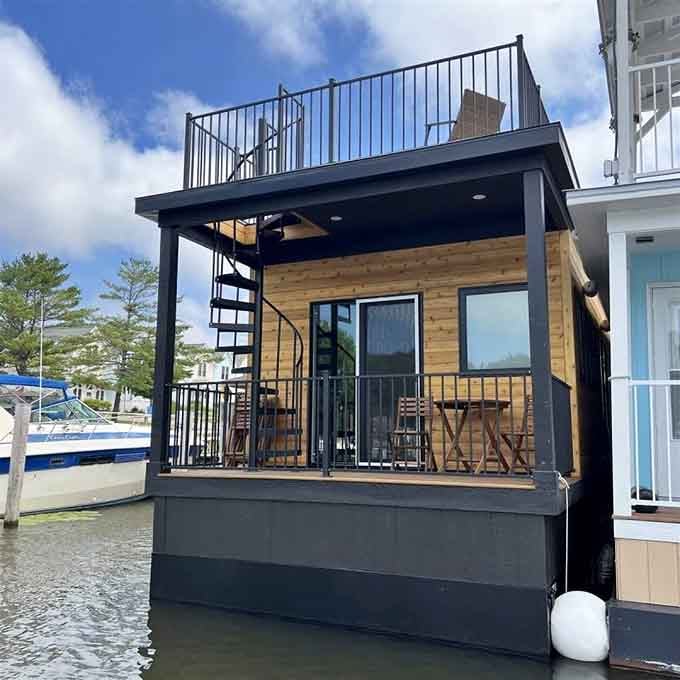 Modern design meets floating innovation with this sleek cabin featuring natural wood accents and a rooftop observation deck.