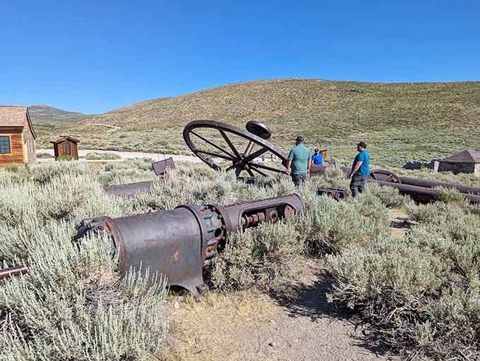 Visitors explore the scattered machinery and artifacts, walking through history that's tangible enough to touch but forbidden to take.