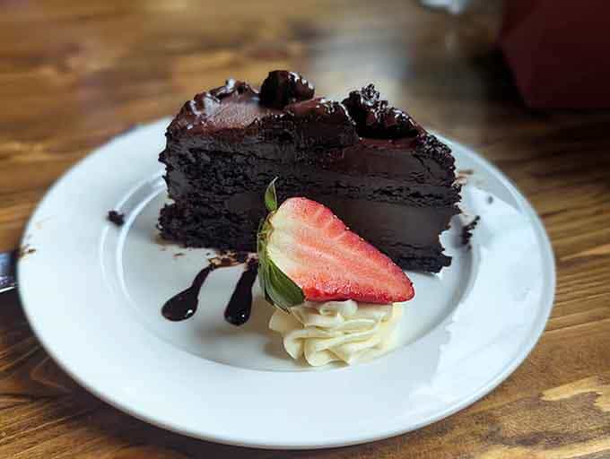 Chocolate cake so decadent it makes other desserts jealous, layered like a delicious architectural achievement you'll happily demolish.