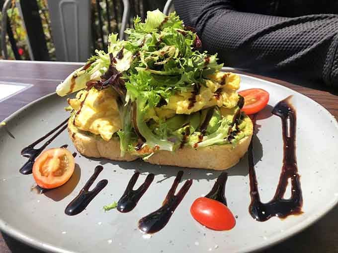 Avocado Toast gets the gourmet treatment with greens, balsamic drizzle, and artistic plating flair.