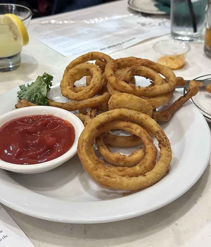 Onion rings stacked like edible golden bracelets, crispy enough to hear the crunch from the next table over.