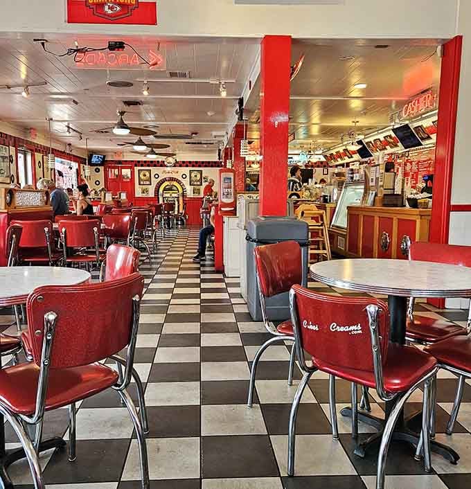 Red accents pop against black and white floors in a space designed for lingering over coffee and conversation.