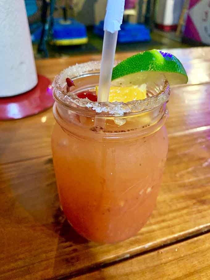 The strawberry mango margarita arrives with a salted rim and enough fruity flavor to transport you straight to vacation mode.