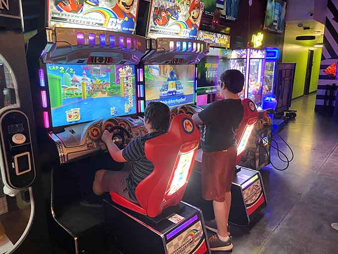 Kids discovering the magic of arcade racing, proving some joys transcend generations and never go out of style.
