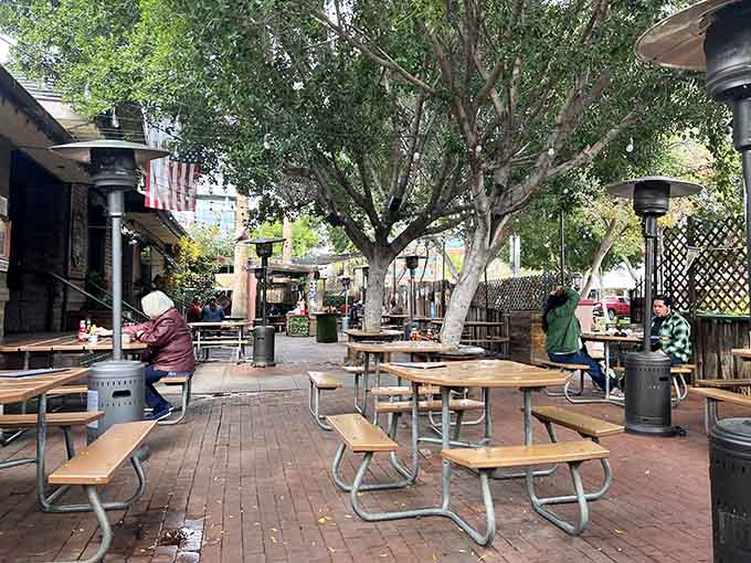 Picnic tables under towering trees turn any Tuesday into a weekend getaway without the drive.