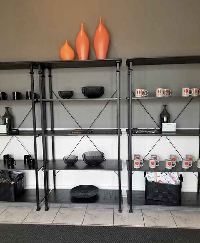 Shelves displaying mugs and d&eacute;cor that add homey touches without cluttering the clean, modern aesthetic throughout.