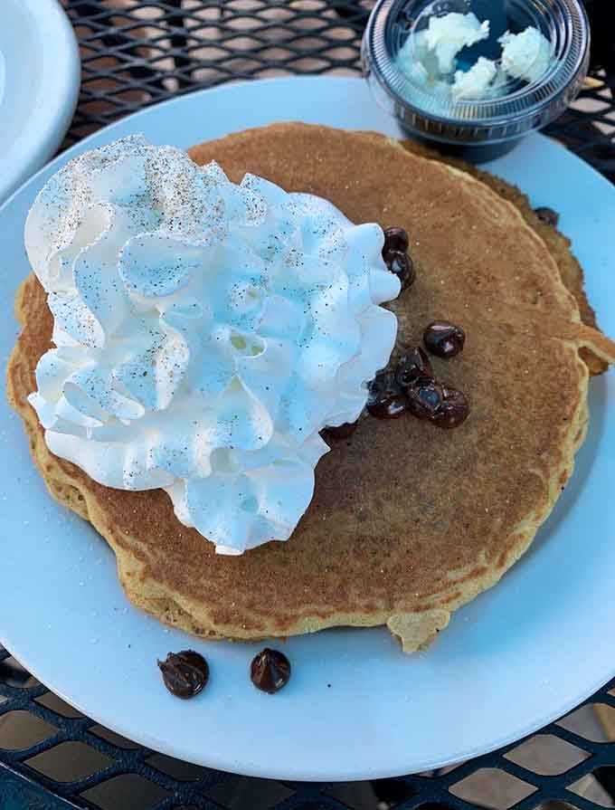 Fluffy pancakes topped with whipped cream show that Chef Zorba's breakfast game extends far beyond Mediterranean specialties alone.