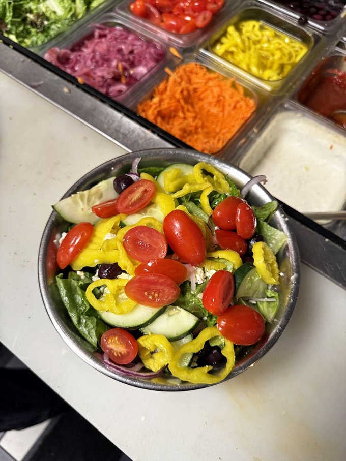 Fresh salad bar setup proving that even burger joints understand balance, though we're still ordering the fries.