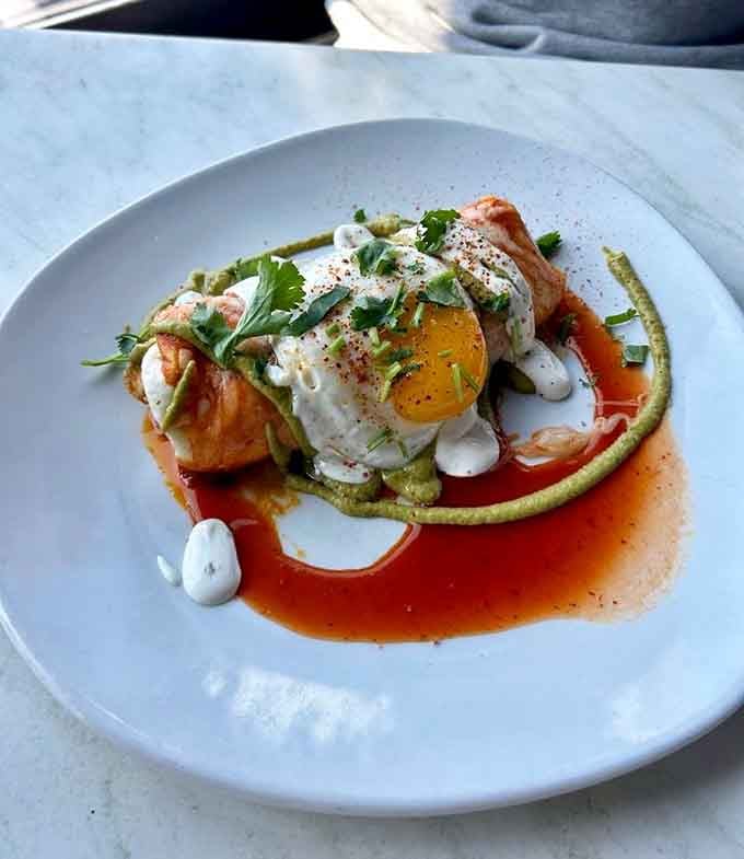 Chorizo enchilada plated with artistic flair, where that perfectly runny egg yolk becomes your own personal sauce masterpiece.