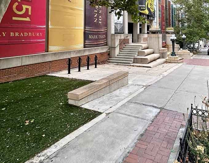 Even the sidewalk benches get a front-row seat to this spectacular display of oversized literary ambition.