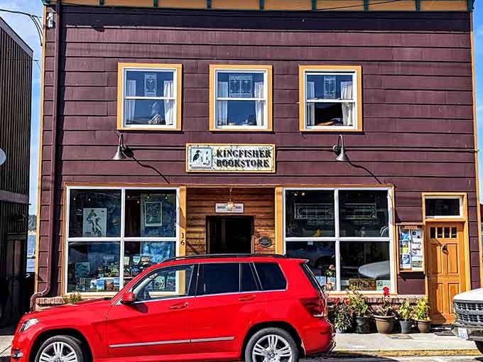 This burgundy bookstore wears its literary heart on its wooden sleeve, complete with vintage charm and welcoming windows.