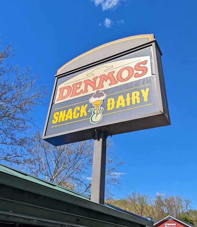 That vintage sign stands tall like a beacon guiding hungry travelers to their delicious destiny below.