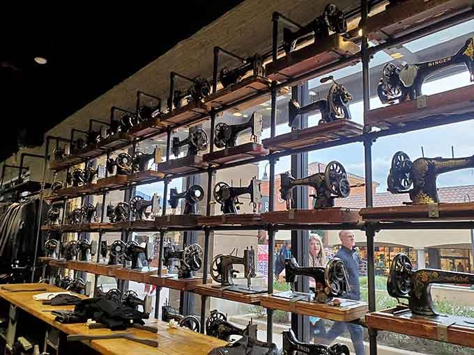 Those antique sewing machines on wooden shelves add unexpected character, like stumbling into your grandmother's attic while shopping.