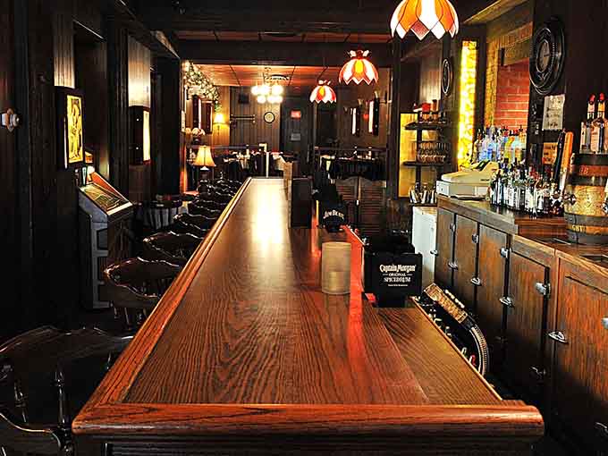 The classic bar stretches invitingly, promising perfectly mixed Old Fashioneds and cold beers to complement your meal.