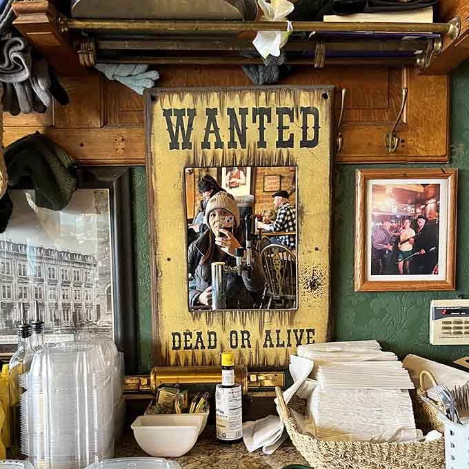 Even the decorative mirror gets the Western treatment with a "Wanted Dead or Alive" poster, proving that attention to detail extends to every corner of this establishment.