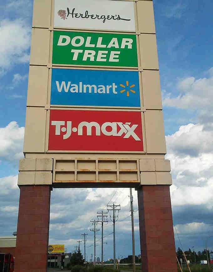 The shopping plaza sign towers above like a monument to retail variety and convenient one-stop errand efficiency.
