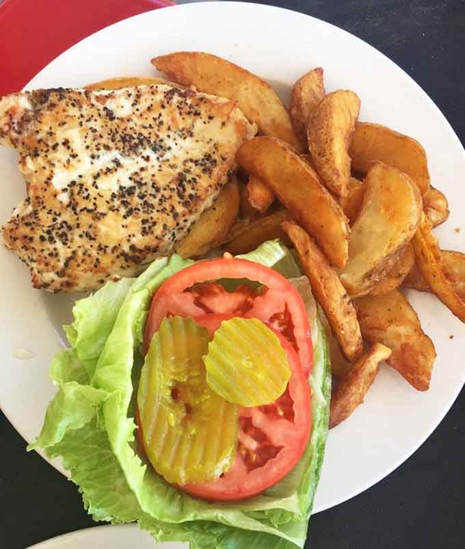 Grilled chicken sandwich with fries that understand their supporting role but still steal the show anyway.