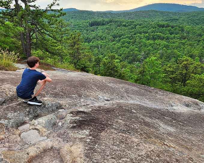 Perched on smooth granite, contemplating endless mountain ridges makes your daily worries seem refreshingly small and manageable.