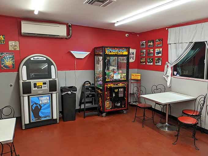 A jukebox and claw machine remind you that entertainment used to require quarters, not Wi-Fi passwords or apps.