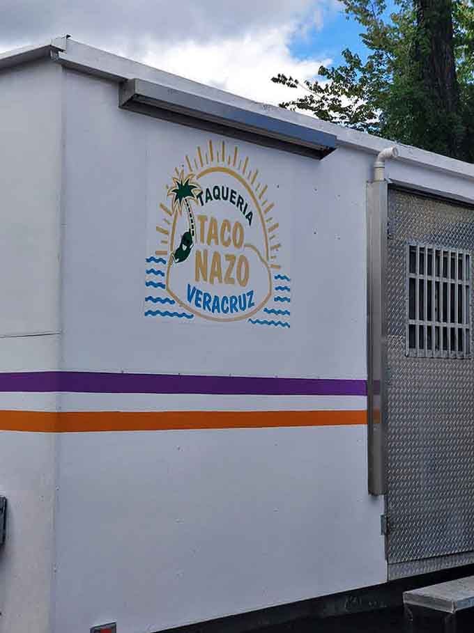 Clean white exterior with cheerful branding, this truck knows presentation starts before the first bite.